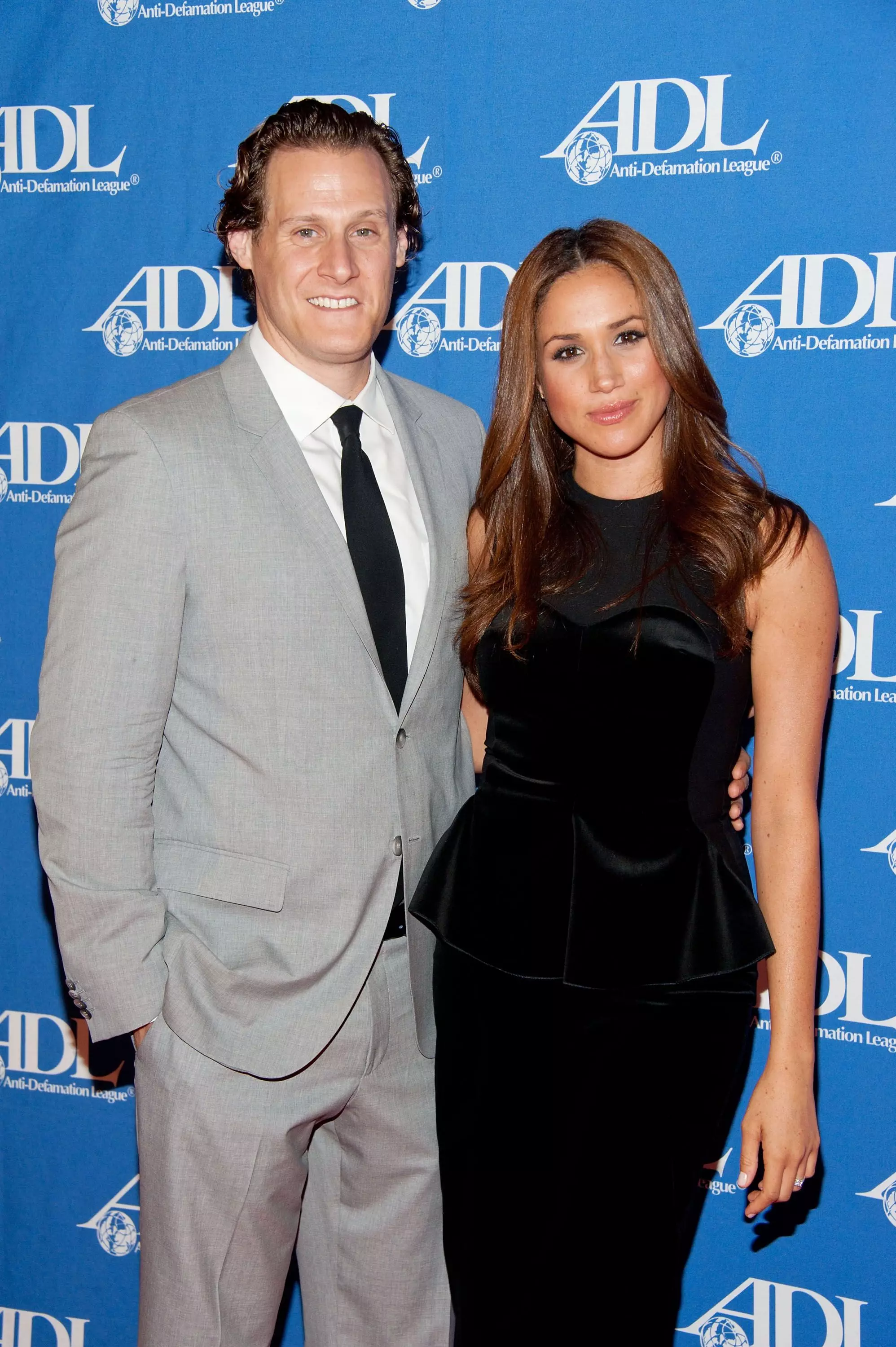 meghan markle and her ex-husband trevor engelson, posing at a photocall