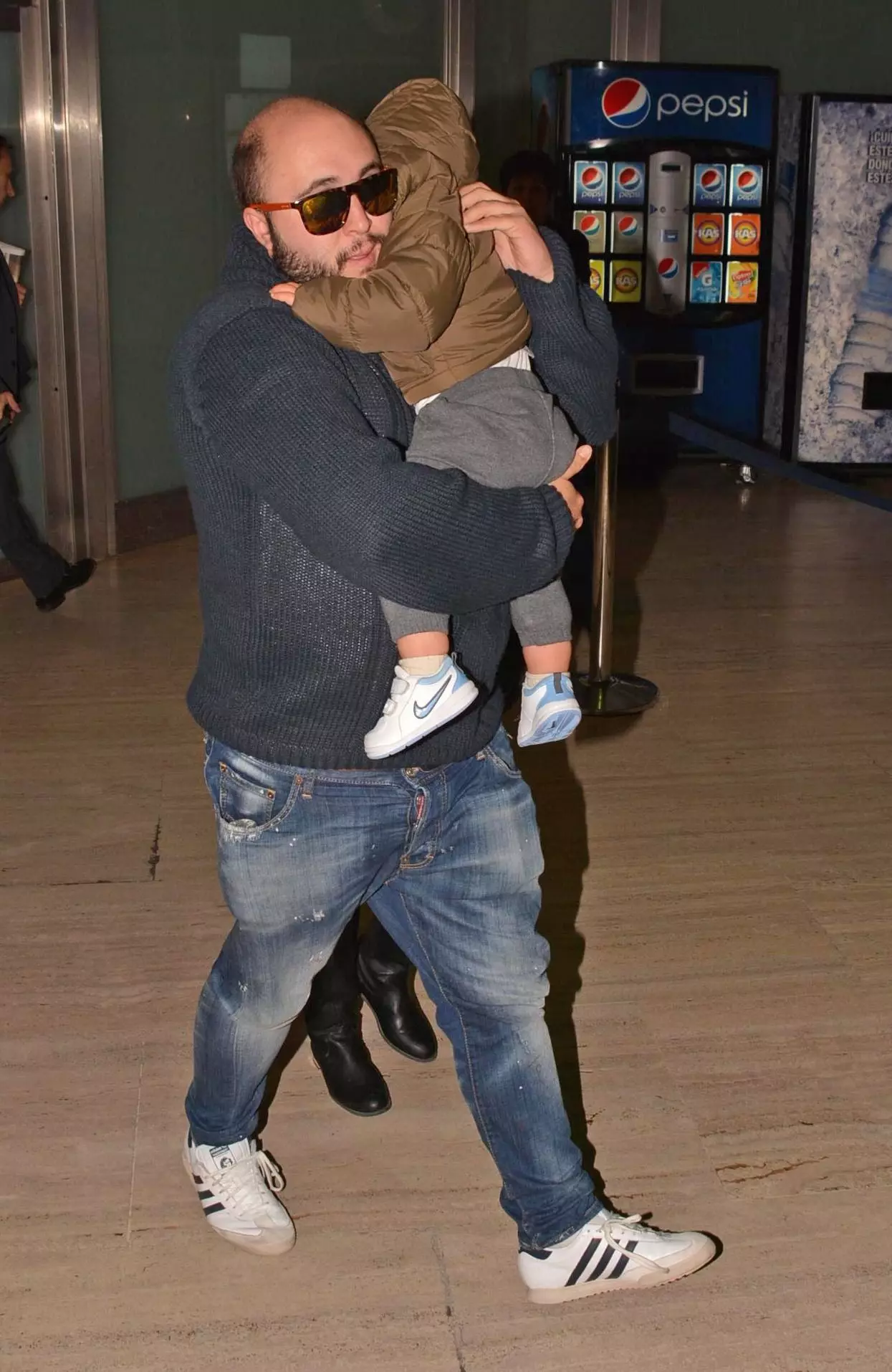 kiko rivera walking with her son, francisco rivera, in seville 2014