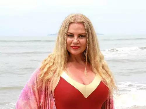 sylvia pantoja posing in a red swimsuit