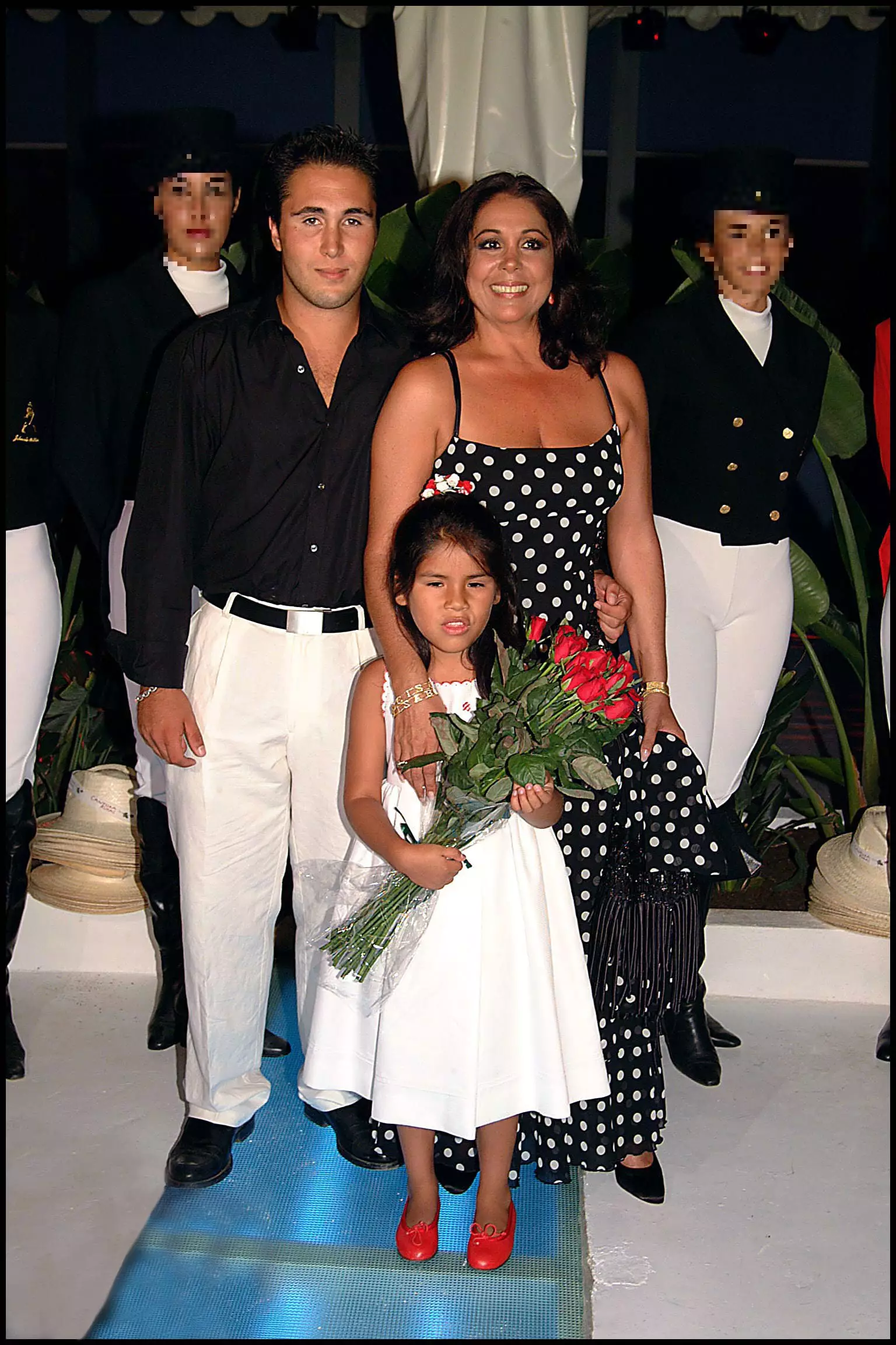 isabel pantoja posing with her children, isabel and kiko, during a celebration when they were little