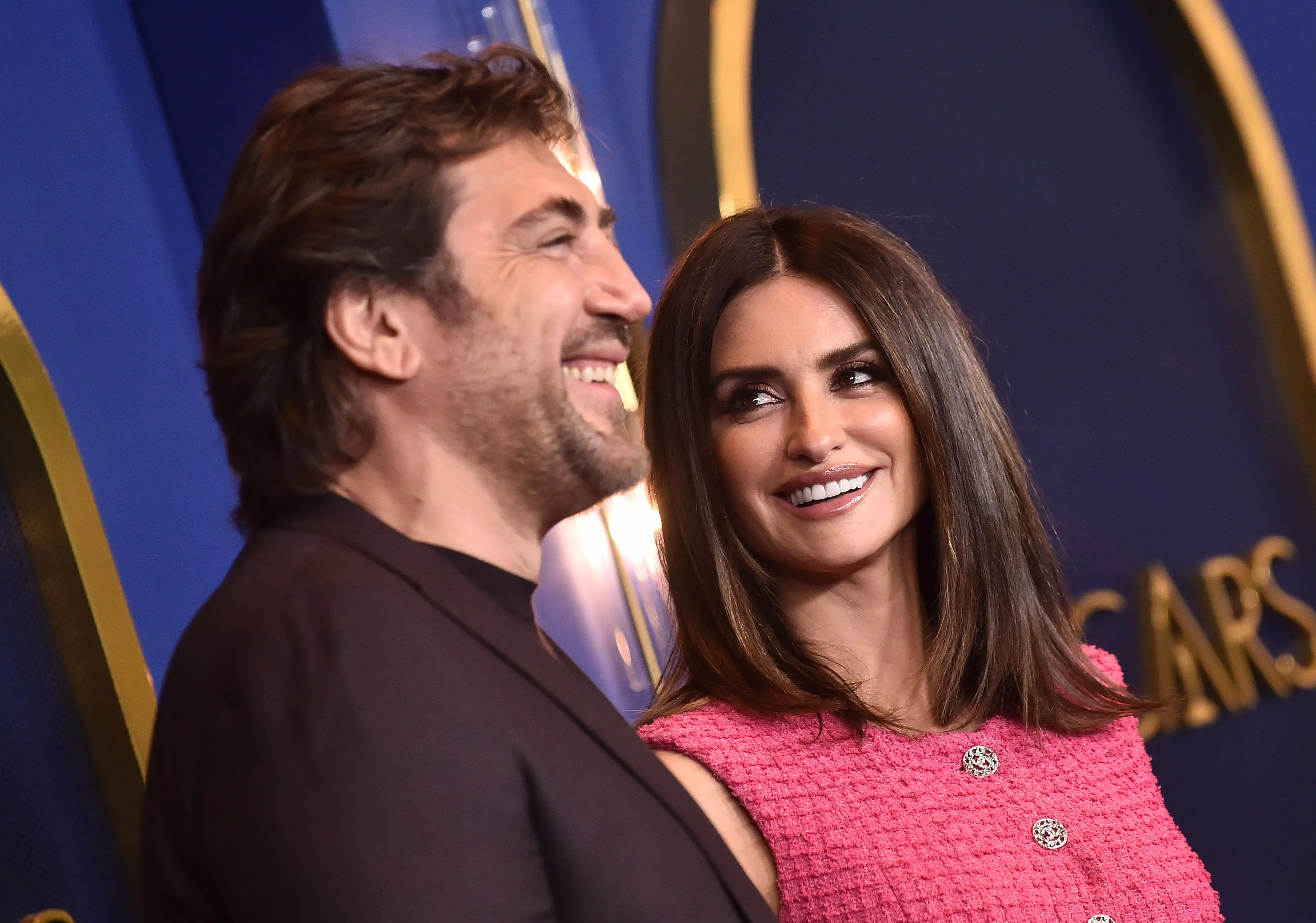 actress penelope cruz in a pink chanel tweed vest minidress with jewel buttons with javier bardem at the oscar nominees luncheon