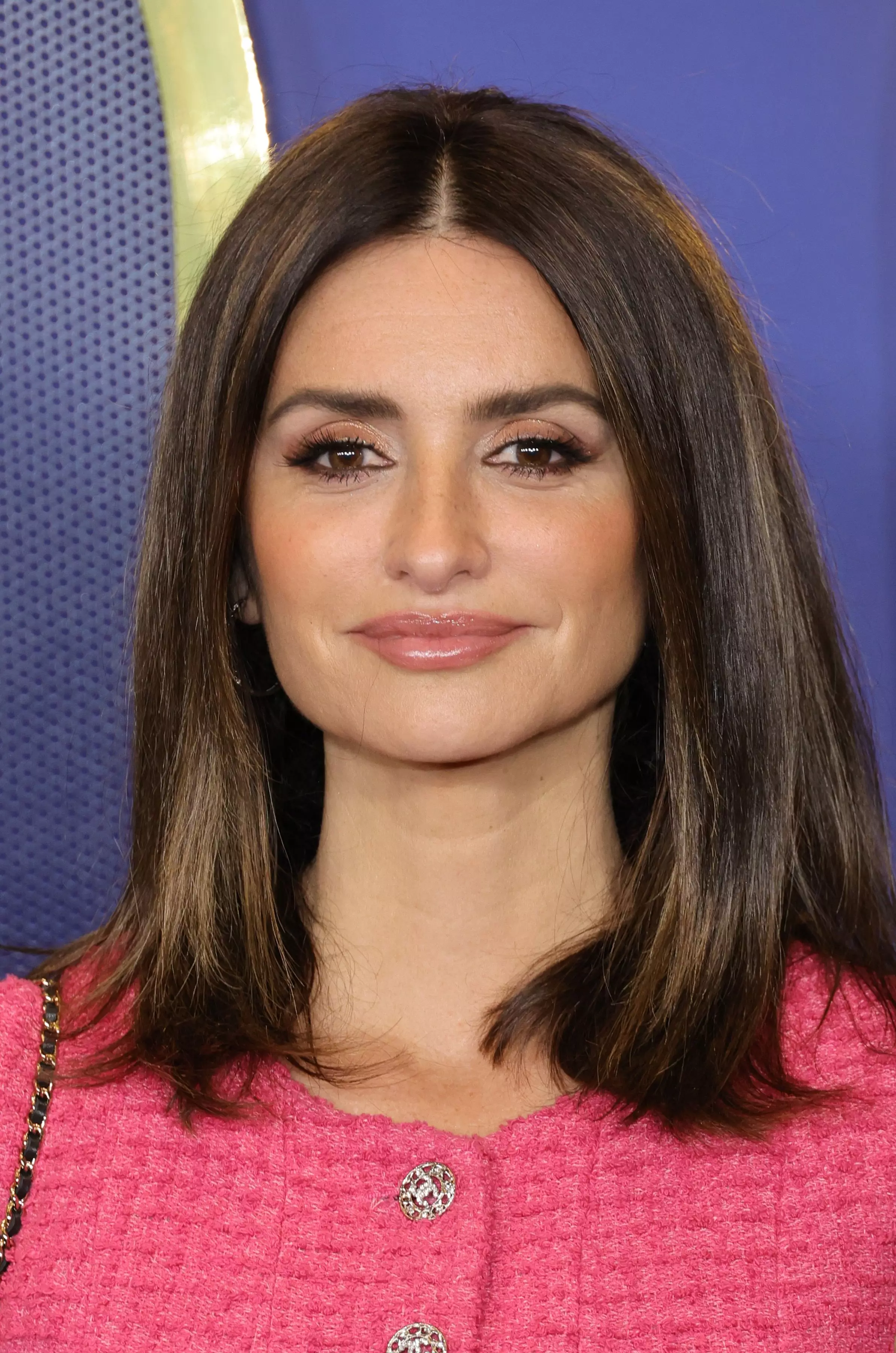 actress penelope cruz in a pink chanel tweed vest minidress with jewel buttons with javier bardem at the oscar nominees luncheon