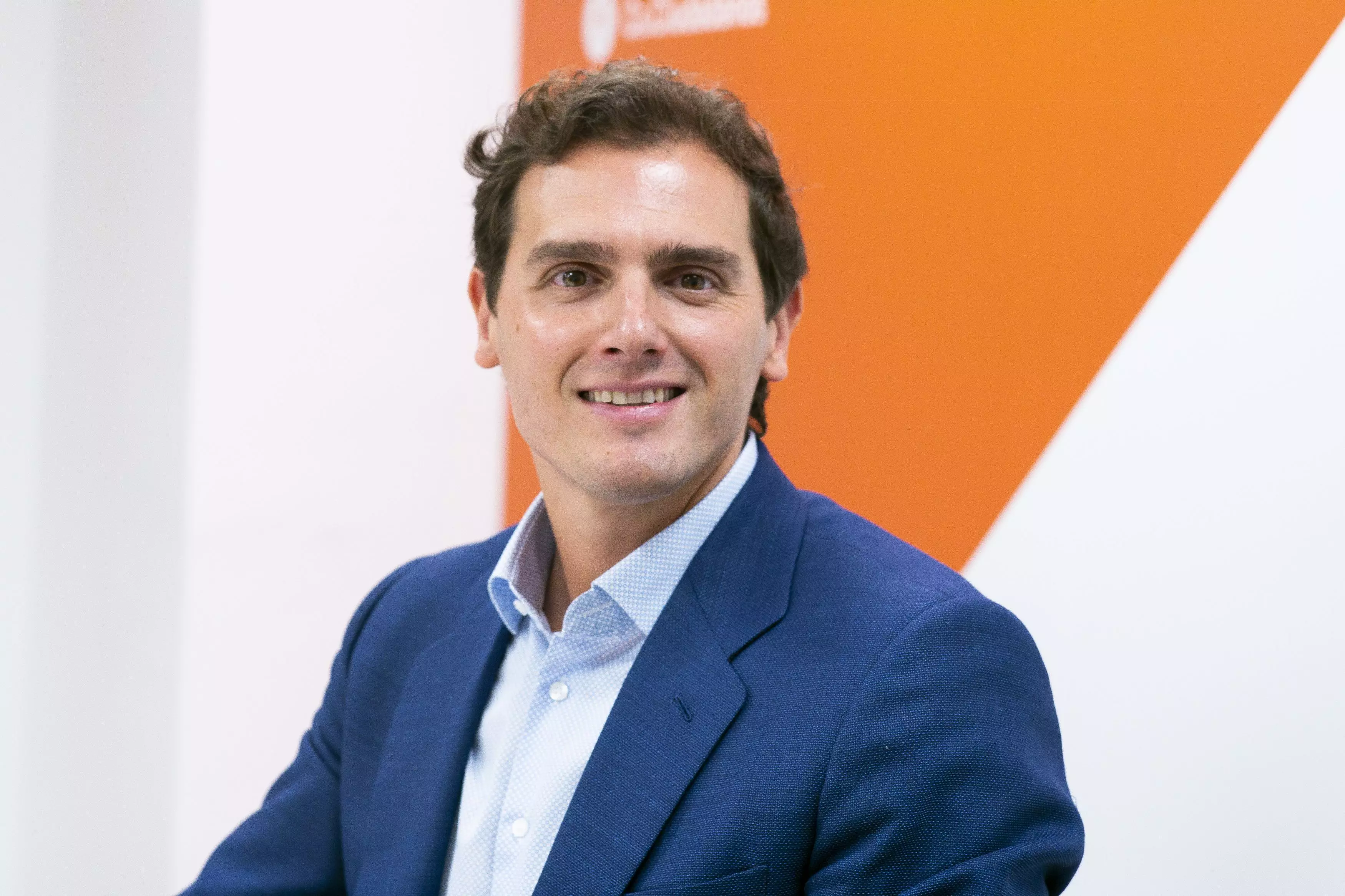 Bývalý prezident Ciudadanos Albert Rivera pózuje s úsměvem, zatímco sedí v ústředí Ciudadanos