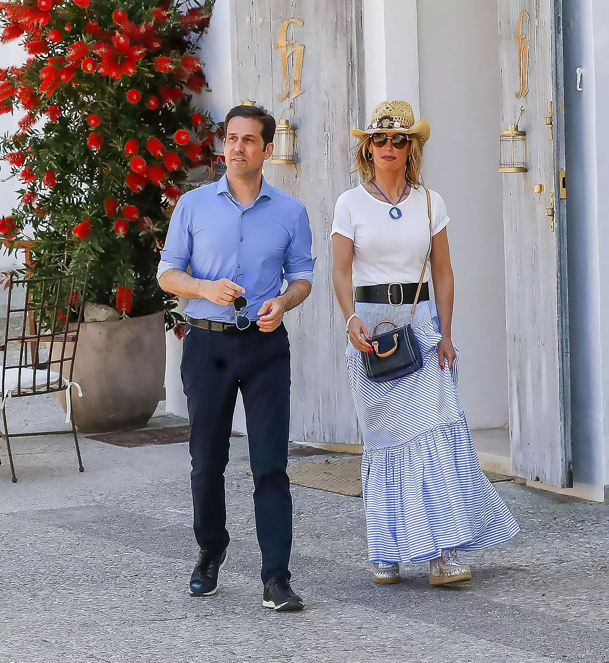 the presenter of 'viva la vida' and her husband walk through the streets of the Ibizan capital