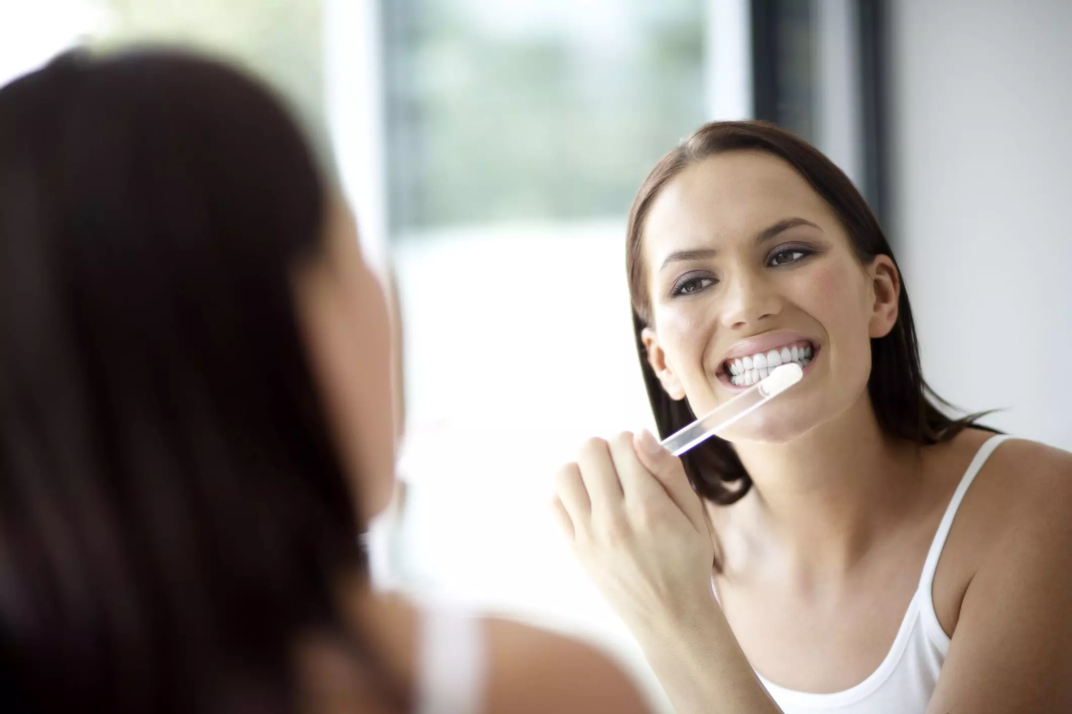 Woman brushing her teeth, close-up