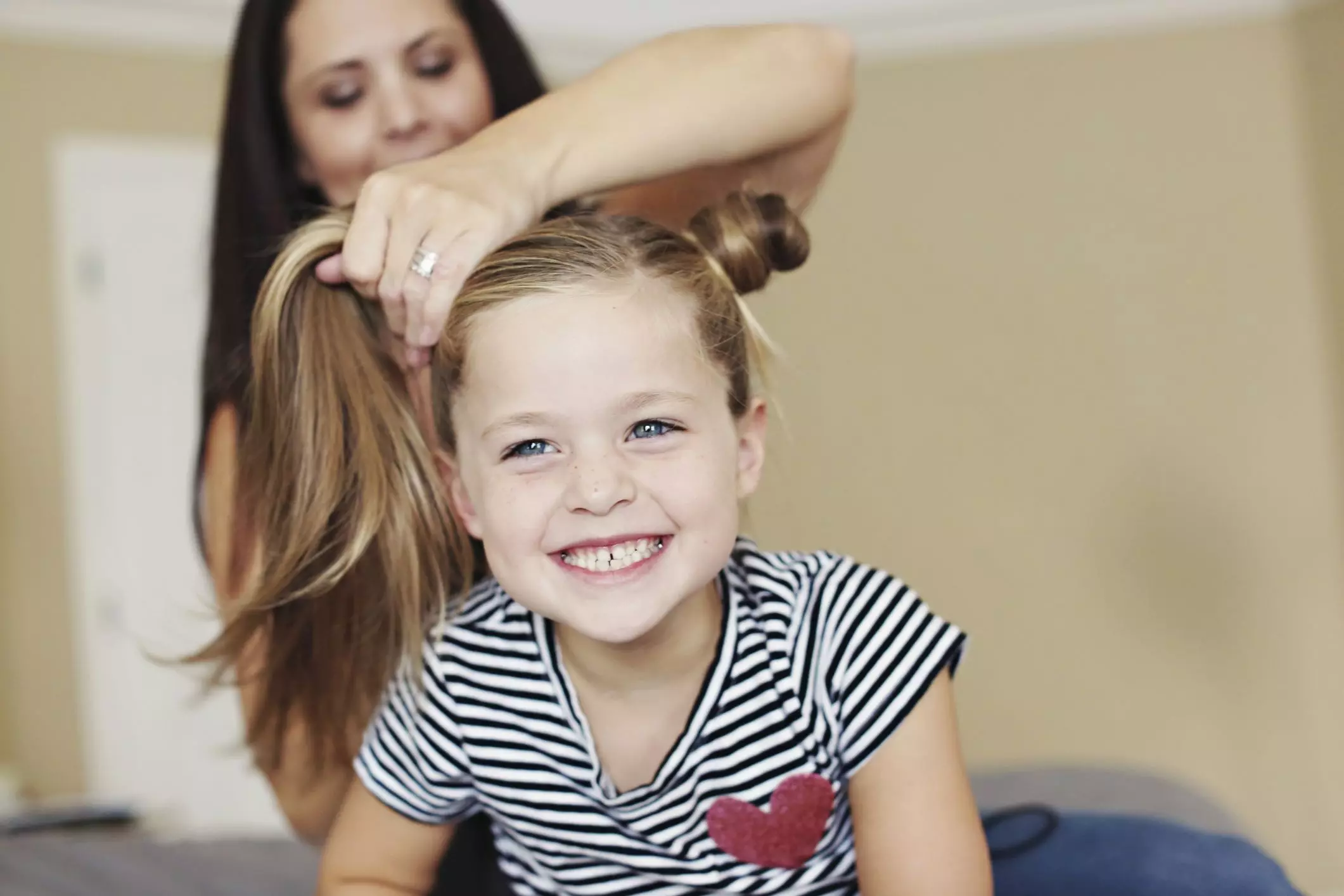 Mutter macht ihrer Tochter eine Frisur