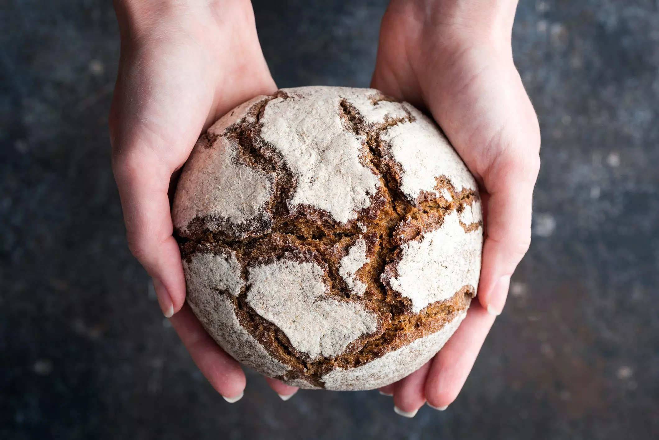 rye bread loaf in female hands