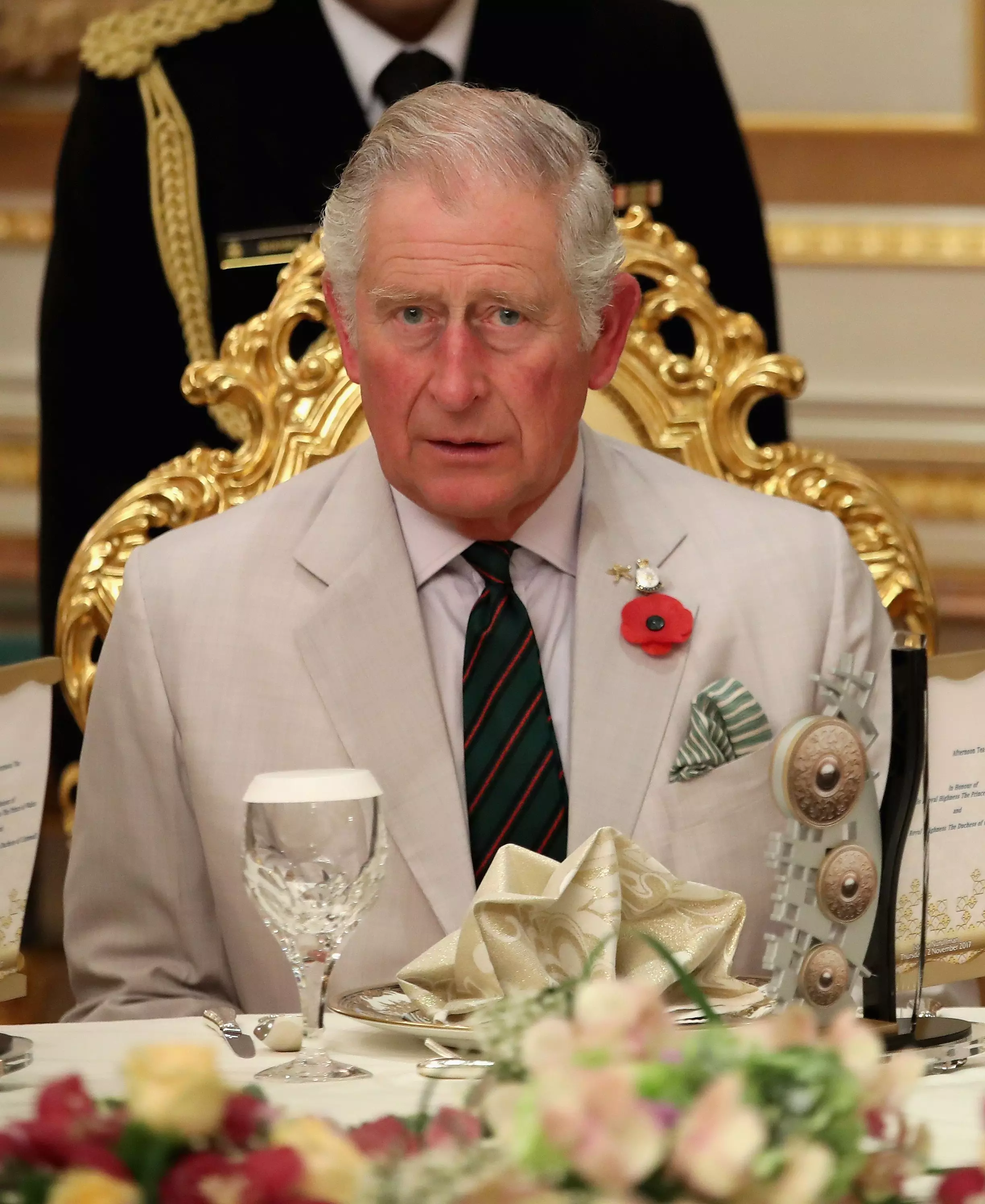 prince charles photographed at a table before eating