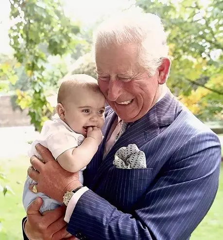 Prince Charles holding his grandson Archie in his arms