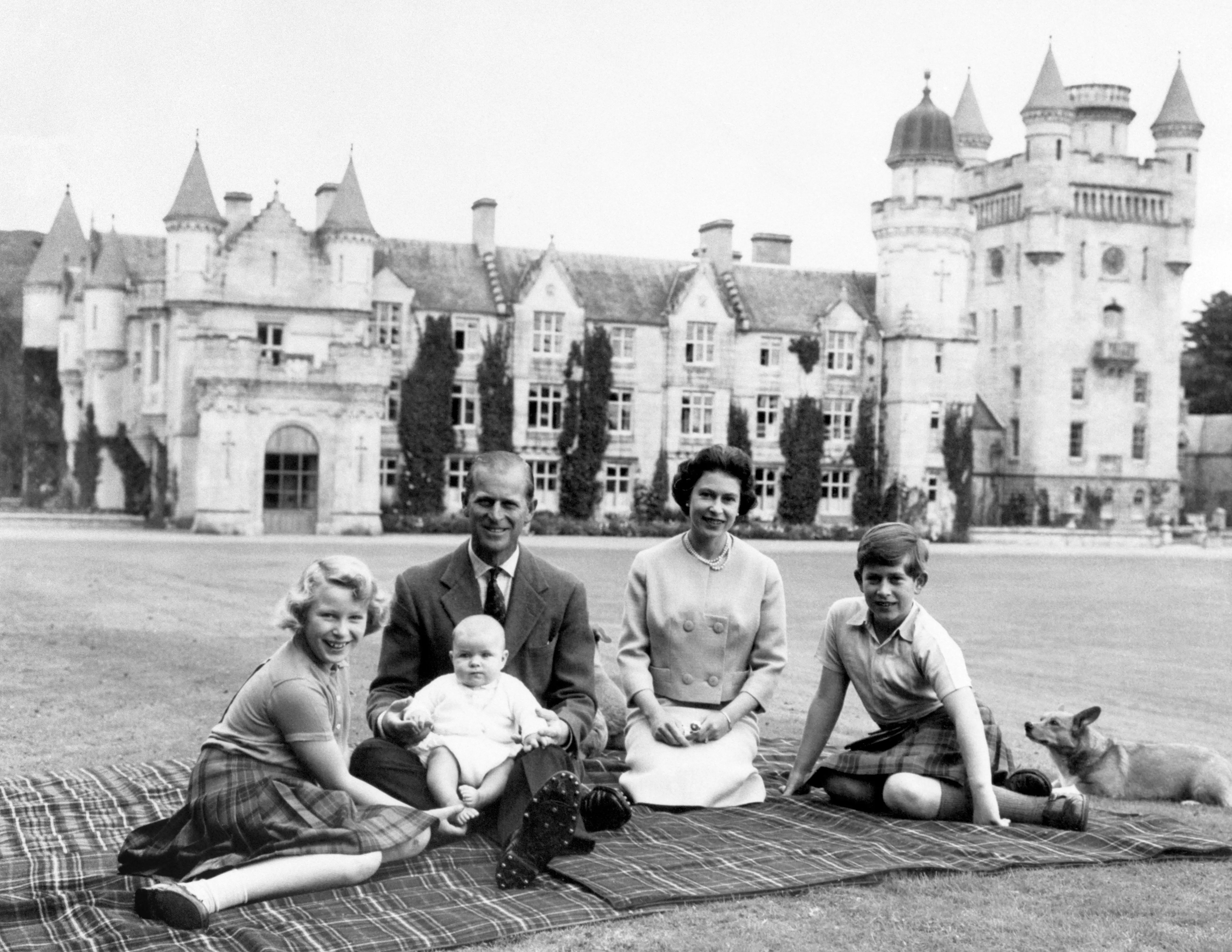 queen elizabeth ii, the duke of edinburgh and three of his children posing seated